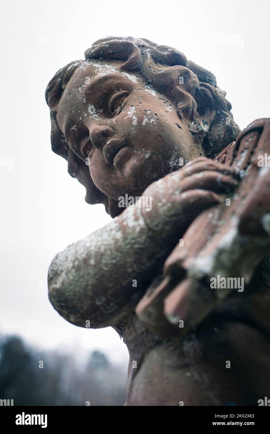 Weathered statue with child face Stock Photo - Alamy