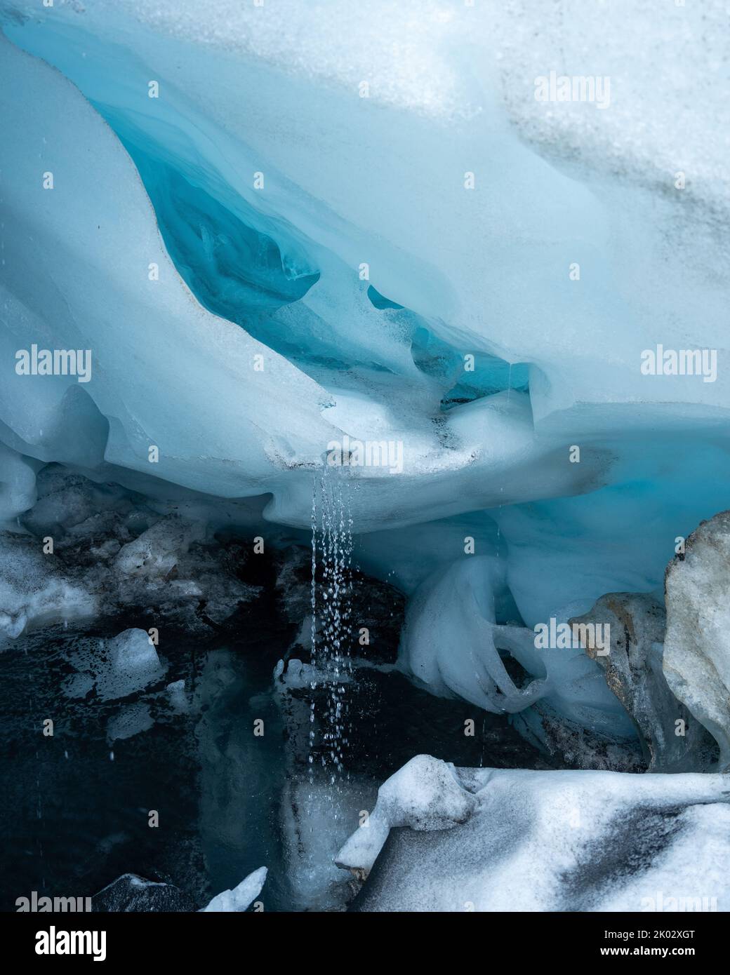 A vertical closeup shot of a glacier with dripping water in a national ...