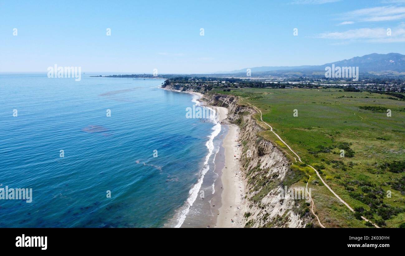 An aerial shot of Mora Mesa Beach in Santa Barbara with waves washing ...