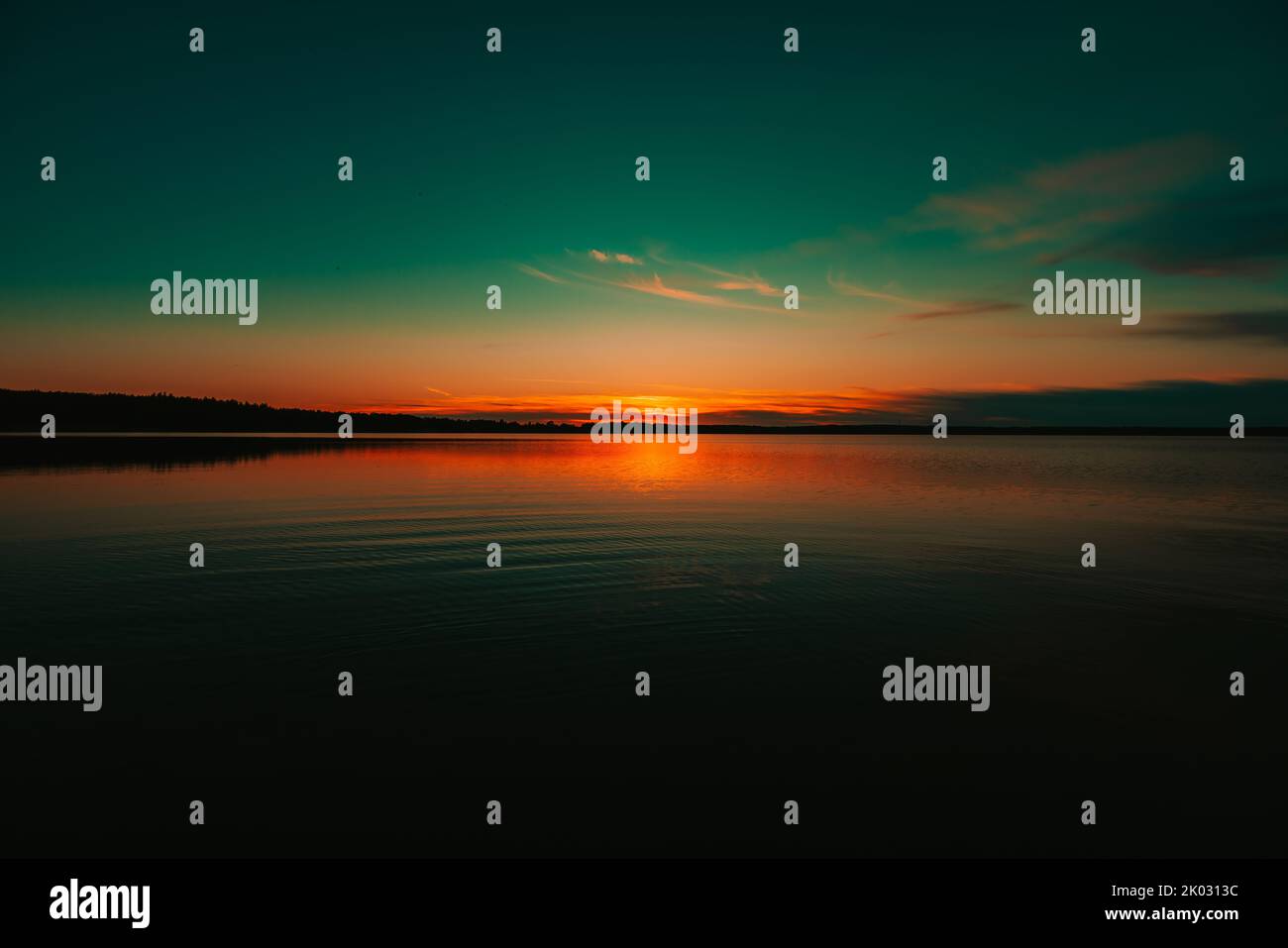 A breathtaking view of a calm sea at orange sunset Stock Photo - Alamy