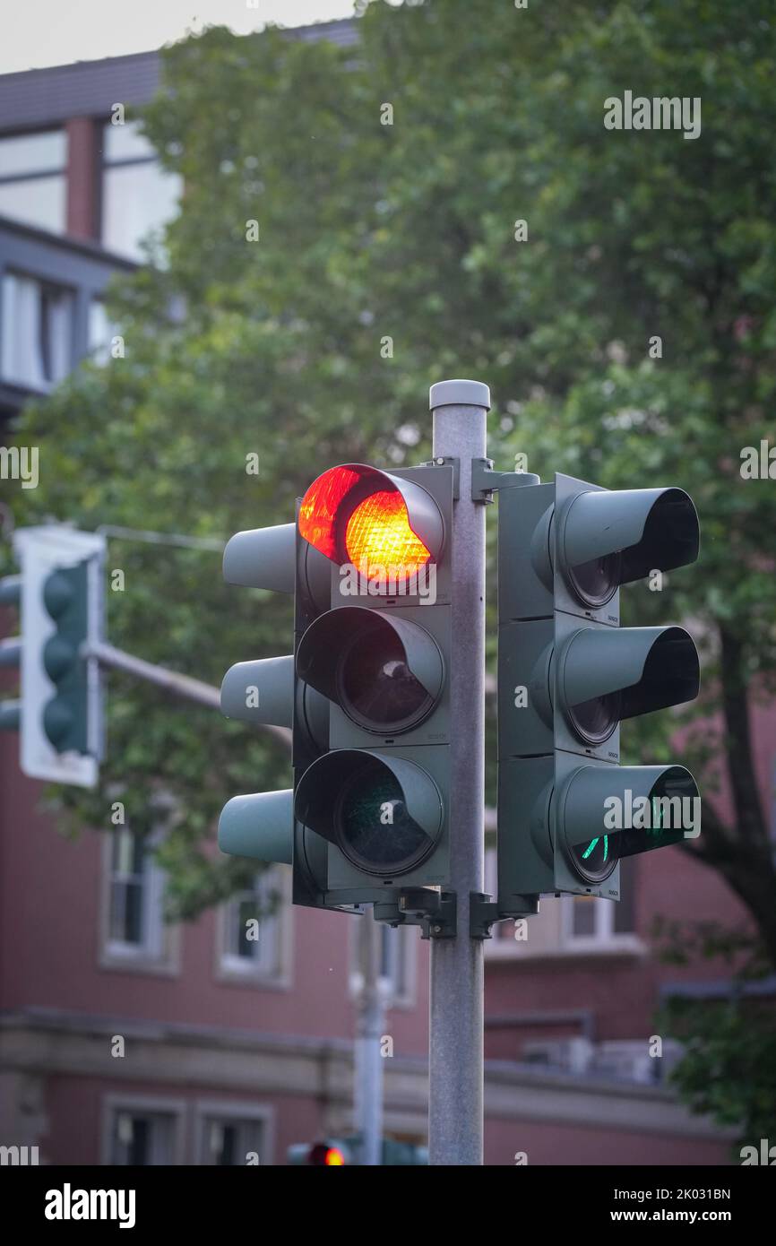 A traffic light on the corner of a street with the red light on Stock ...