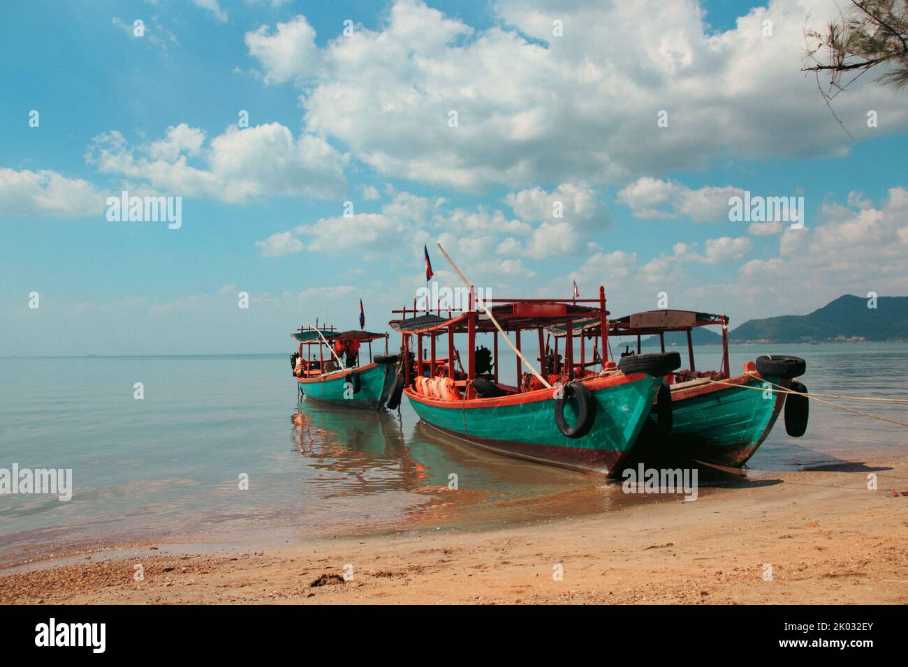 Khmer fishing boats moored at the shore of Koh Tonsay Island or Rabbit ...