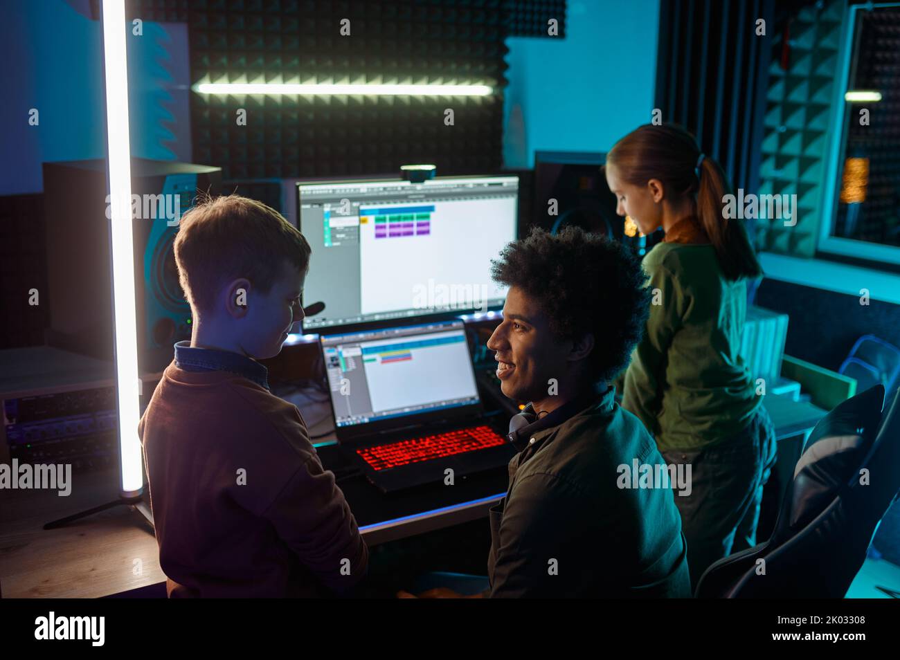 Sound producer mixing track with children band Stock Photo - Alamy