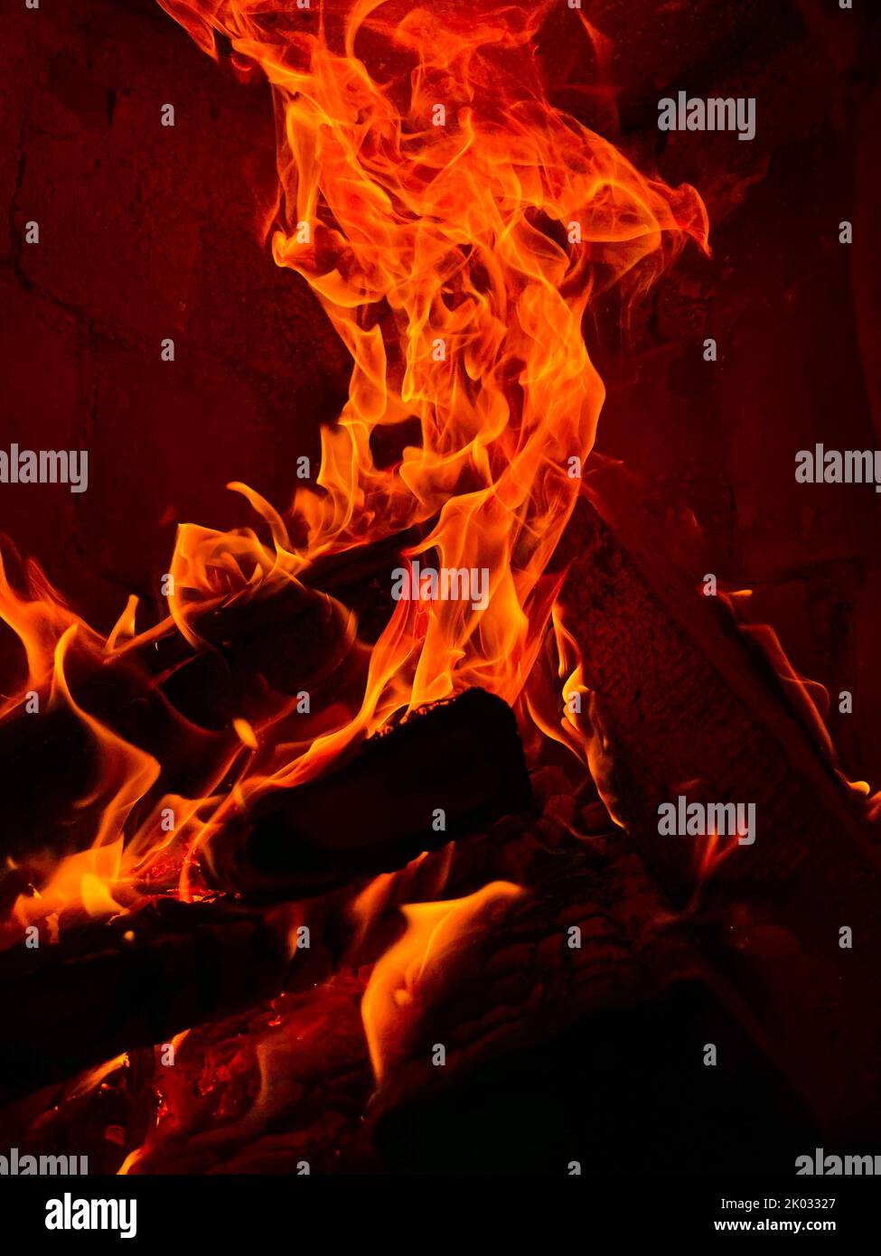 A vertical of a fire burning wood Stock Photo - Alamy