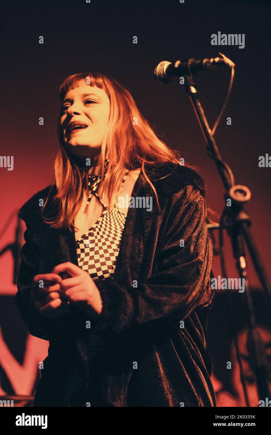 A red-haired attractive Hispanic singer on stage Stock Photo - Alamy