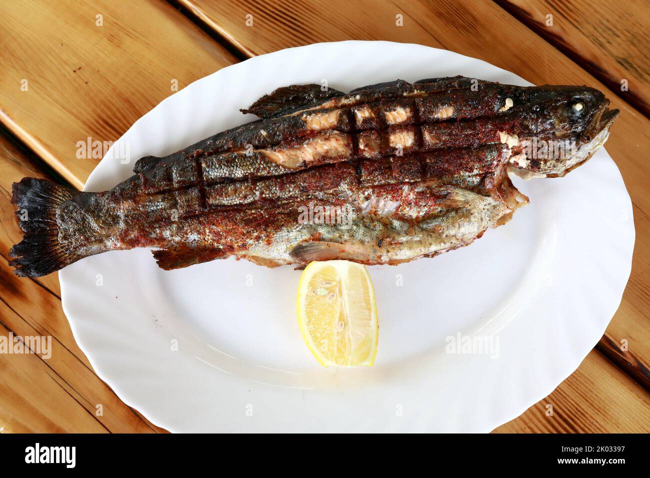 Grilled river trout on plate in restaurant Stock Photo - Alamy