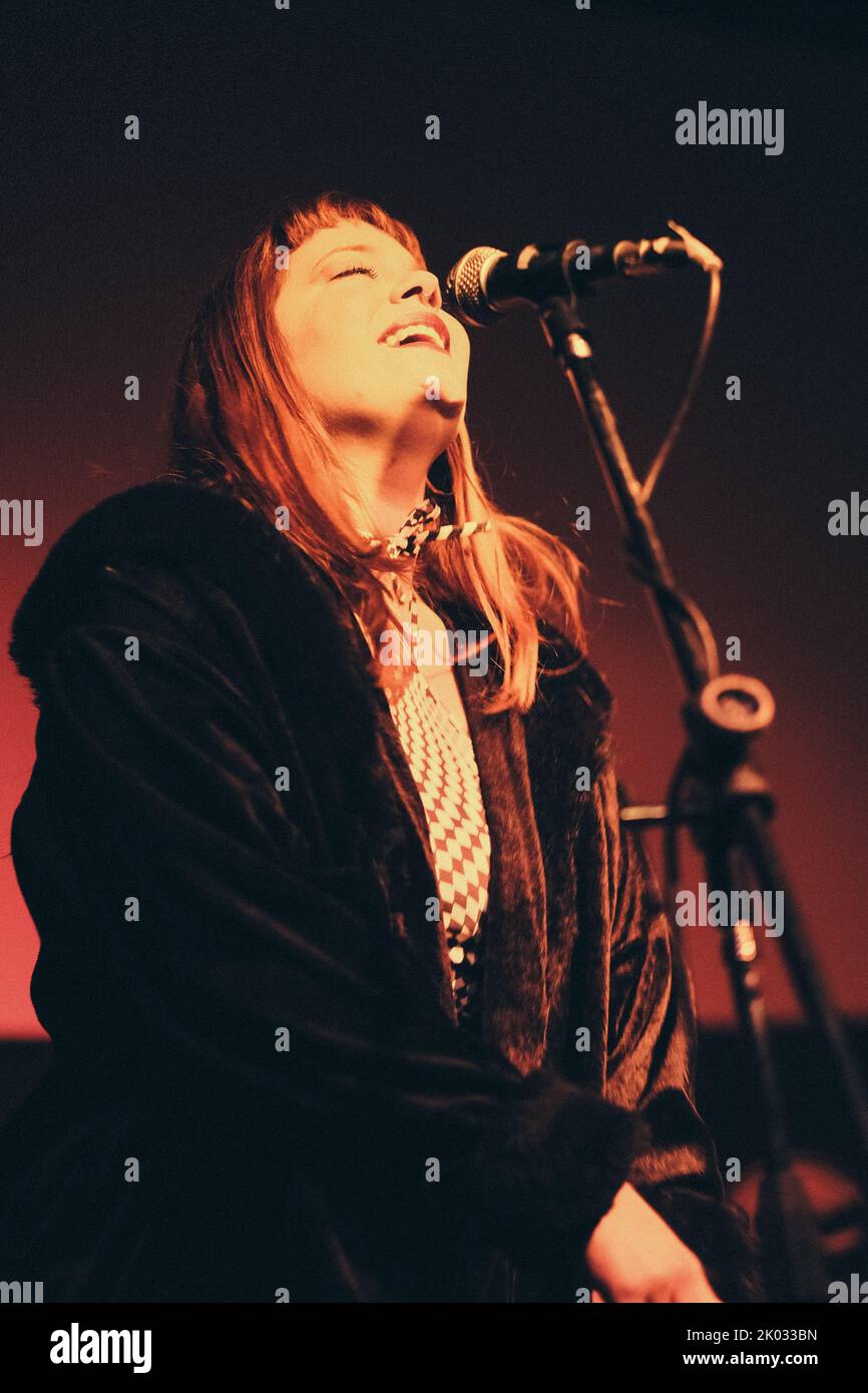 A red-haired attractive Hispanic singer on stage Stock Photo - Alamy