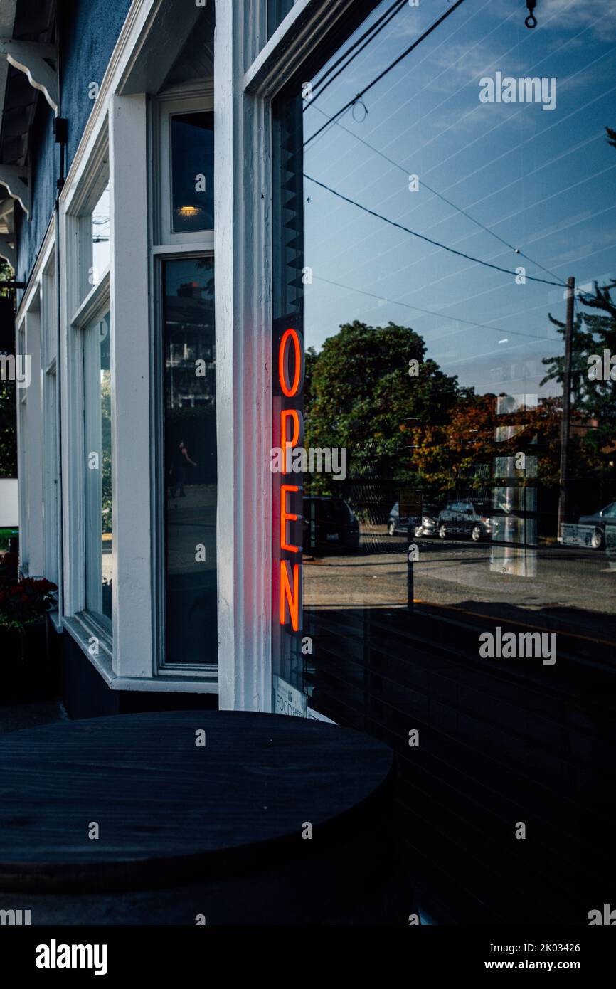 neon red open sign in neighborhood retail store window Stock Photo - Alamy