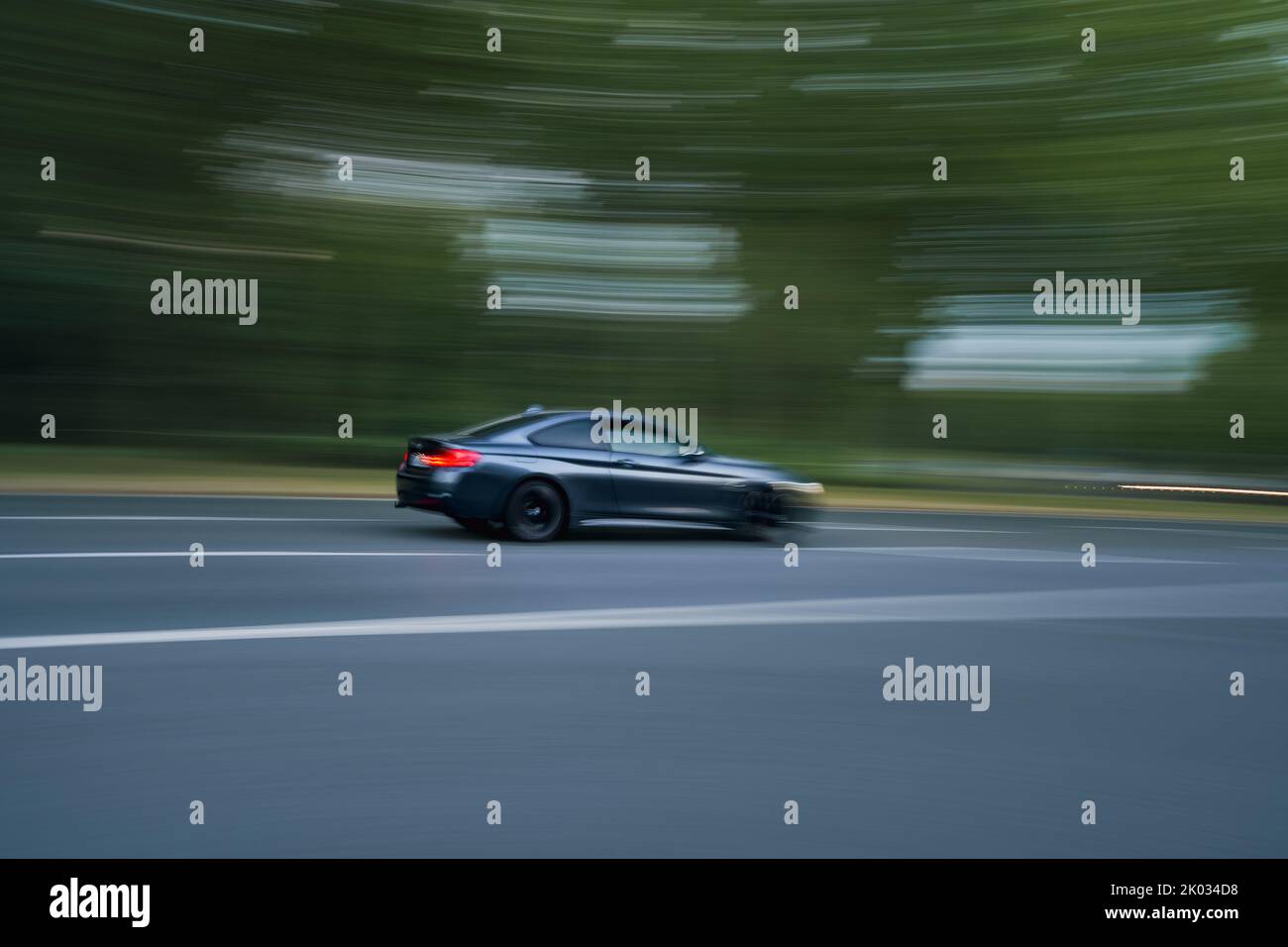A motion blur shot of a car driving fast in a road Stock Photo - Alamy