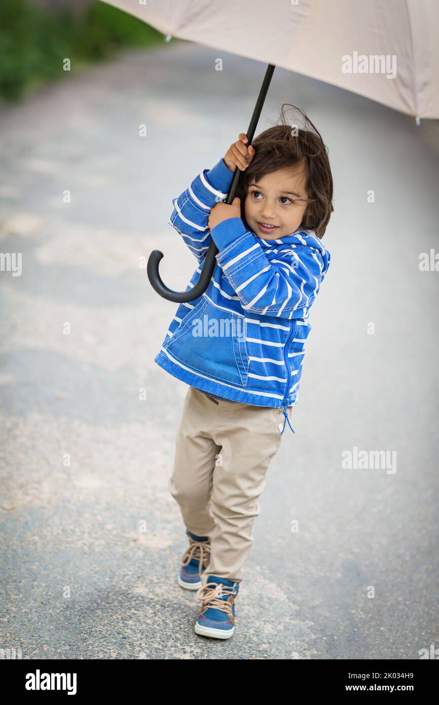 Little eastern handsome baby boy playing with umbrella outdoor Stock ...