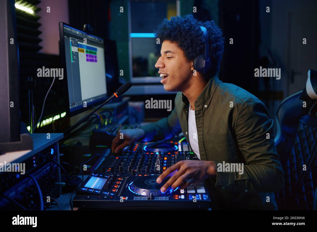 Radio host speaking into microphone Stock Photo - Alamy