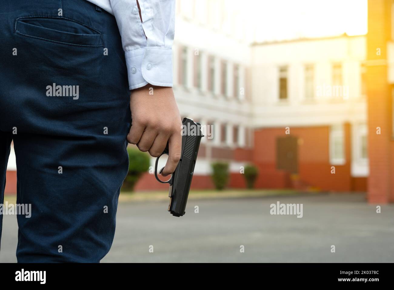 Firearms at school. A teenager with a gun on the background of the ...