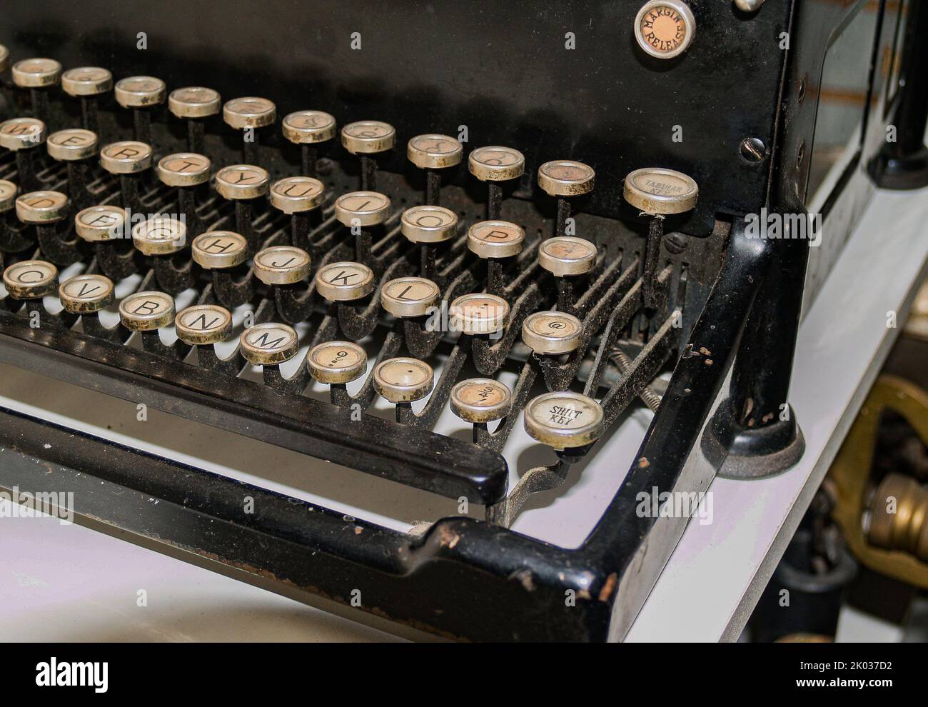 Old well used typewriter keyboard close up with circular keys with ...