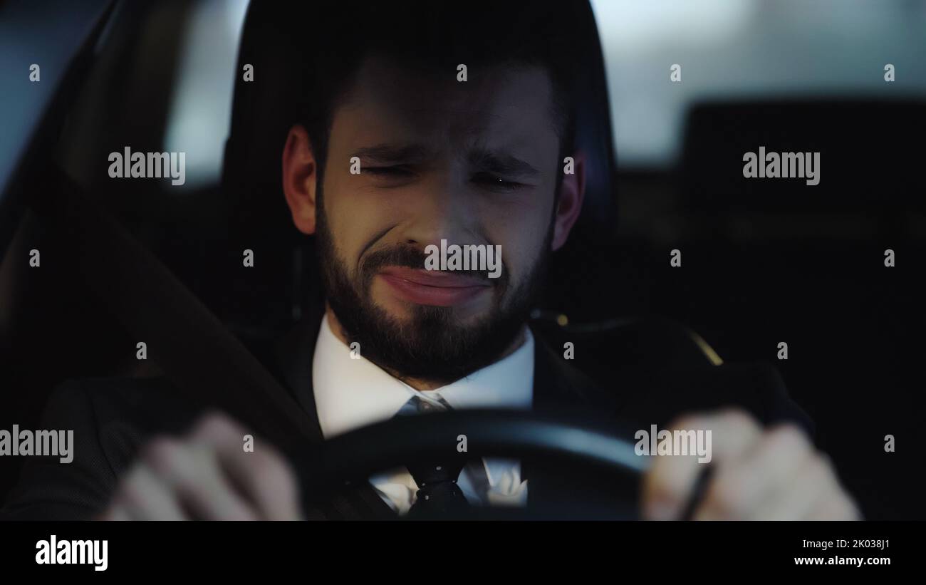 frustrated businessman crying while driving car at night,stock image ...