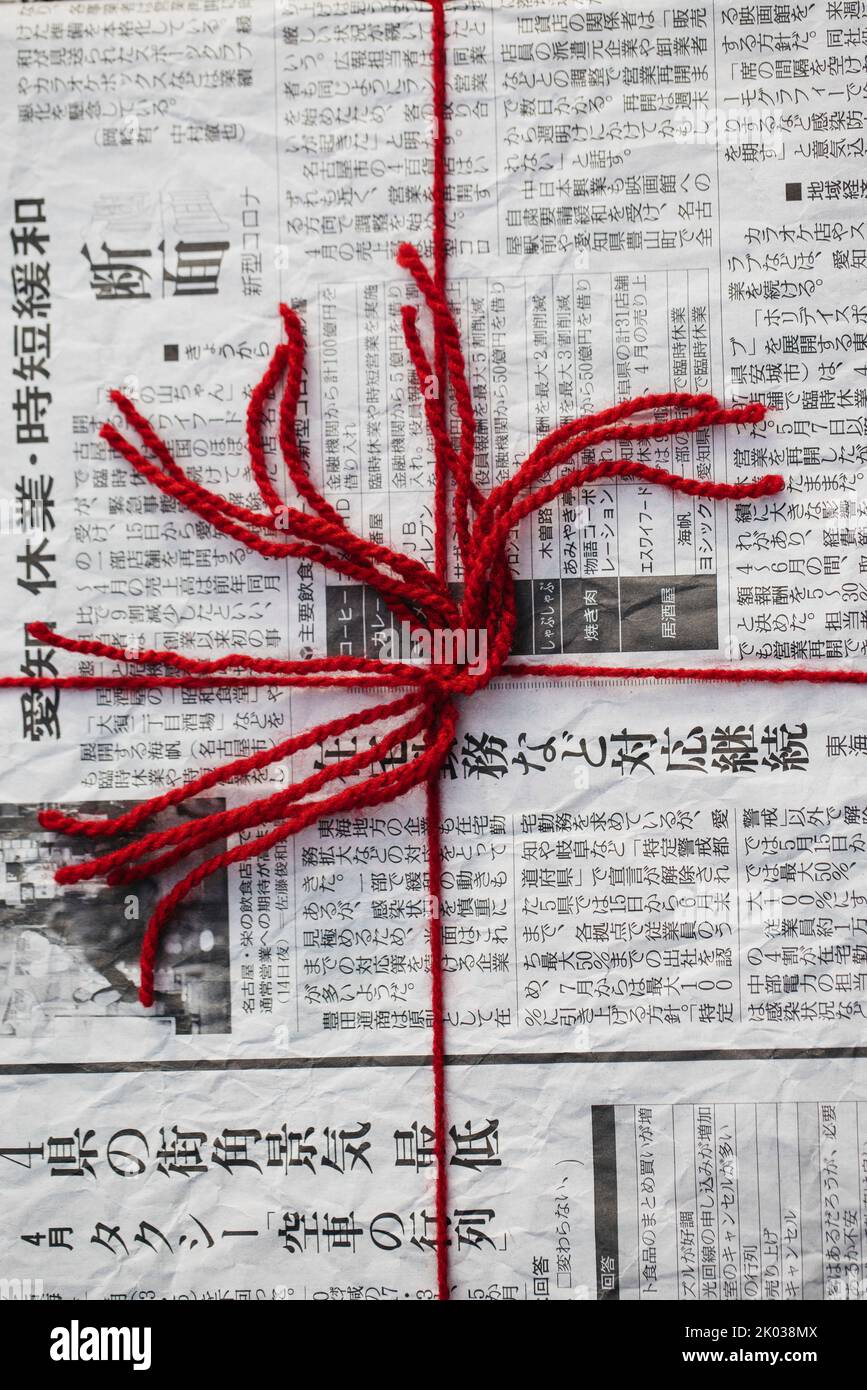 Gift wrapped in used newspaper Stock Photo - Alamy