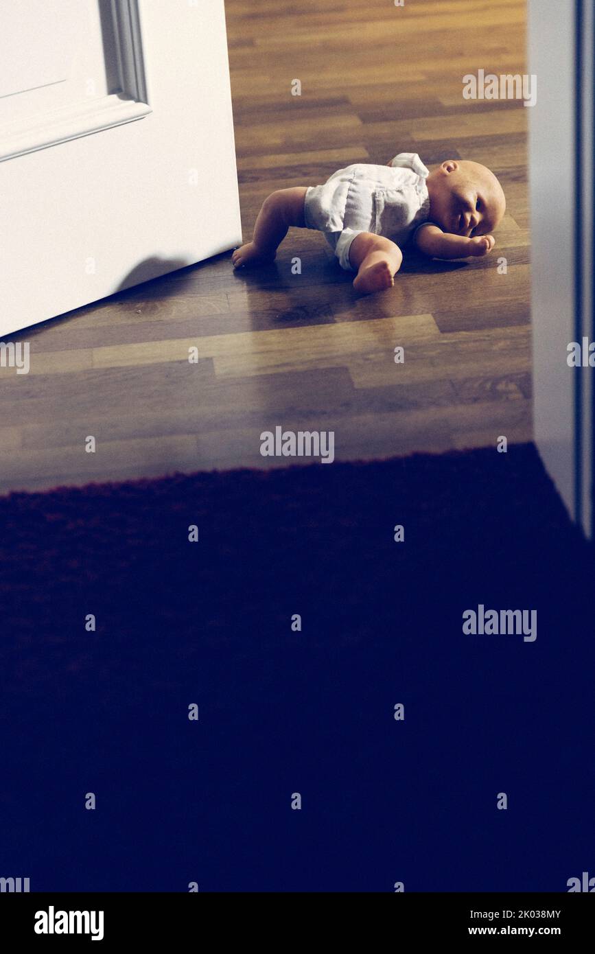 Forgotten doll lying on the floor by a room door Stock Photo - Alamy