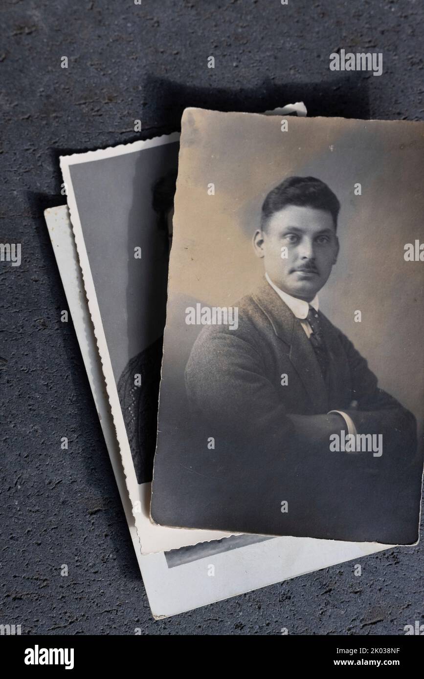 Portrait photo of man on stack of yellowed photos hi-res stock ...
