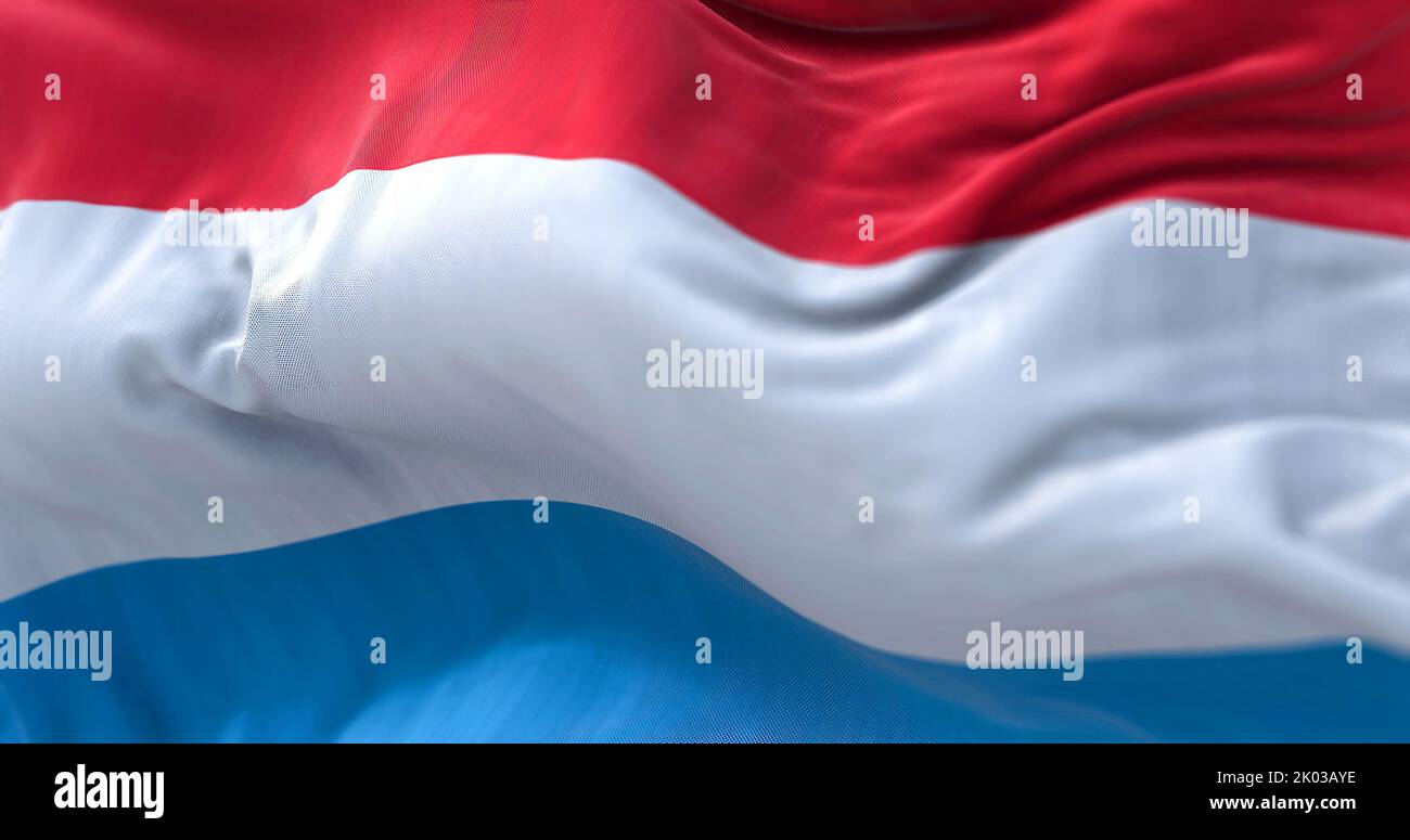 Close-up view of the Luxembourg national flag waving in the wind. The Grand Duchy of Luxembourg ...