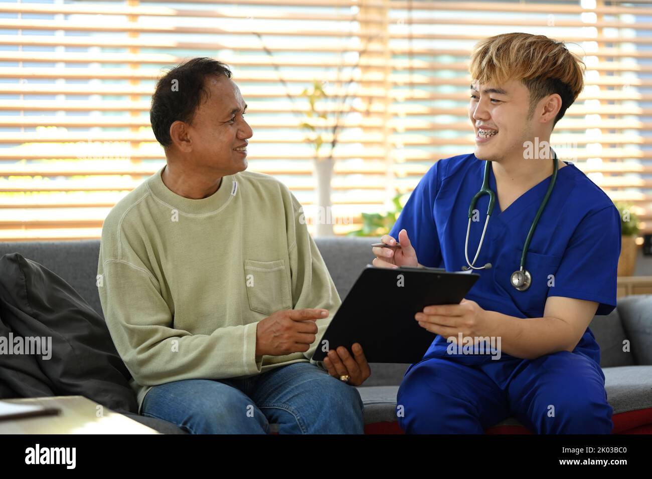 Friendliy doctor giving advice and explaining medical test results to ...