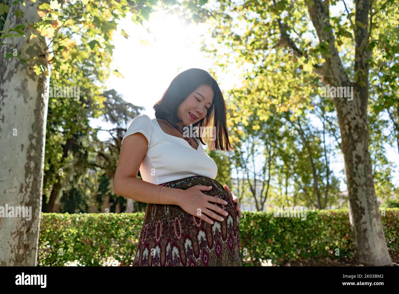 young happy and beautiful Asian Chinese woman posing outdoors happy and ...
