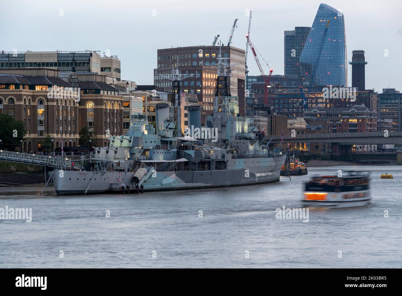 HMS Belfast, museum ship at Tower Bridge, office building behind ...