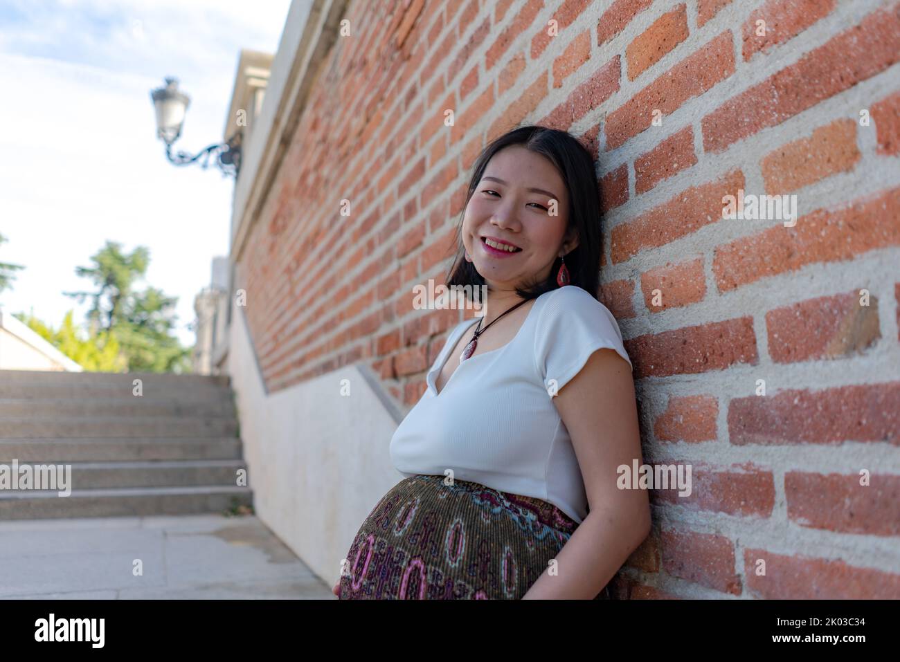 young happy and beautiful Asian Chinese woman posing outdoors happy and ...