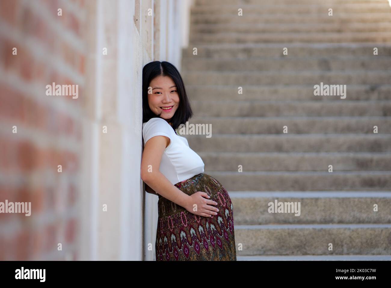 young happy and beautiful Asian Chinese woman posing outdoors happy and ...