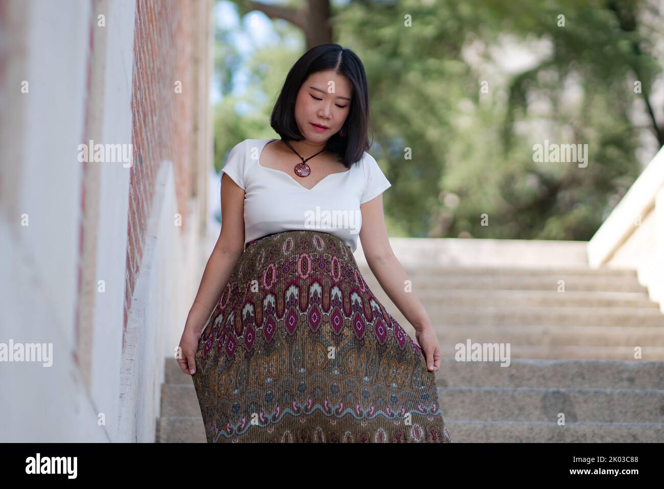 young happy and beautiful Asian Chinese woman posing outdoors happy and ...