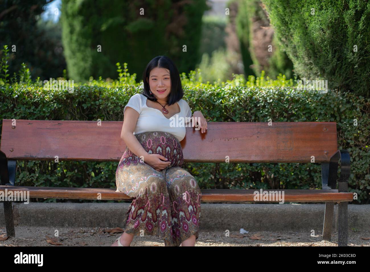 young happy and beautiful Asian Chinese woman pregnant showing her ...