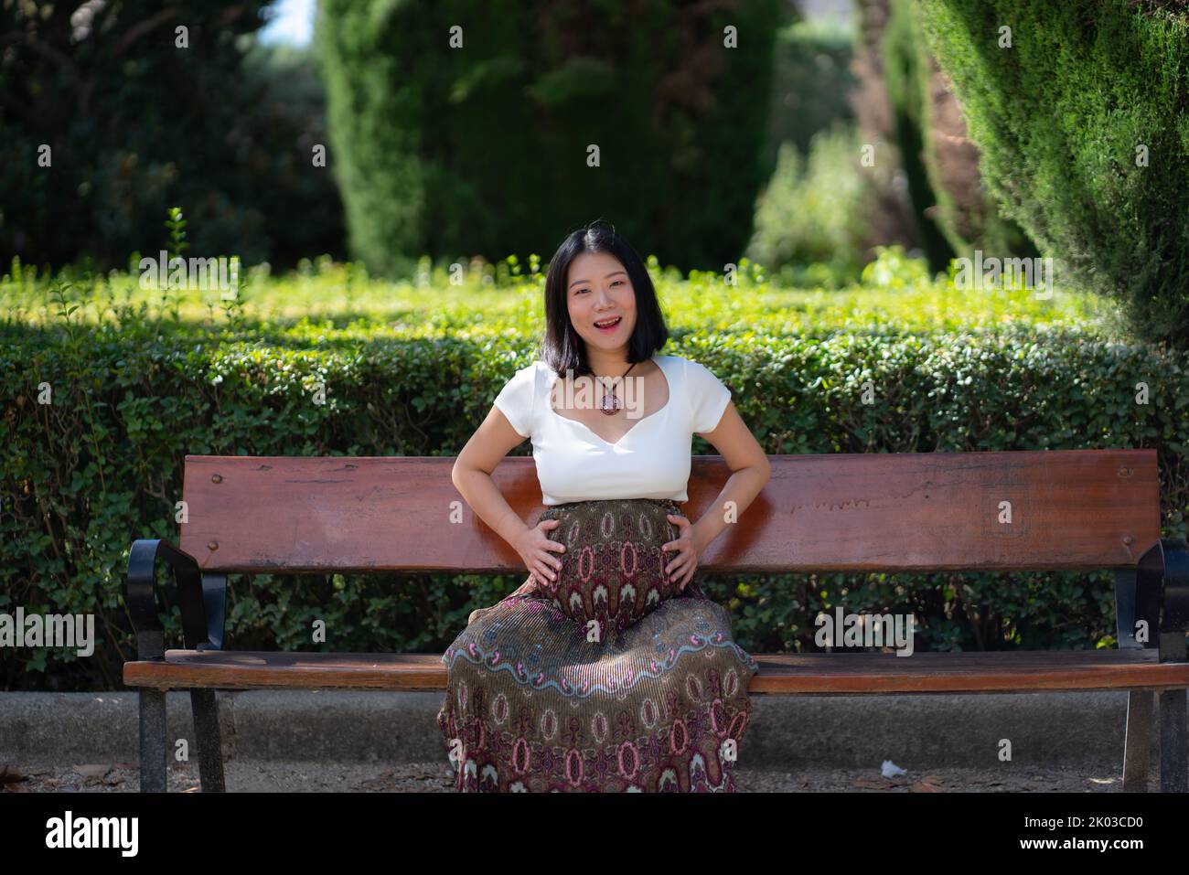 young happy and beautiful Asian Chinese woman pregnant showing her ...