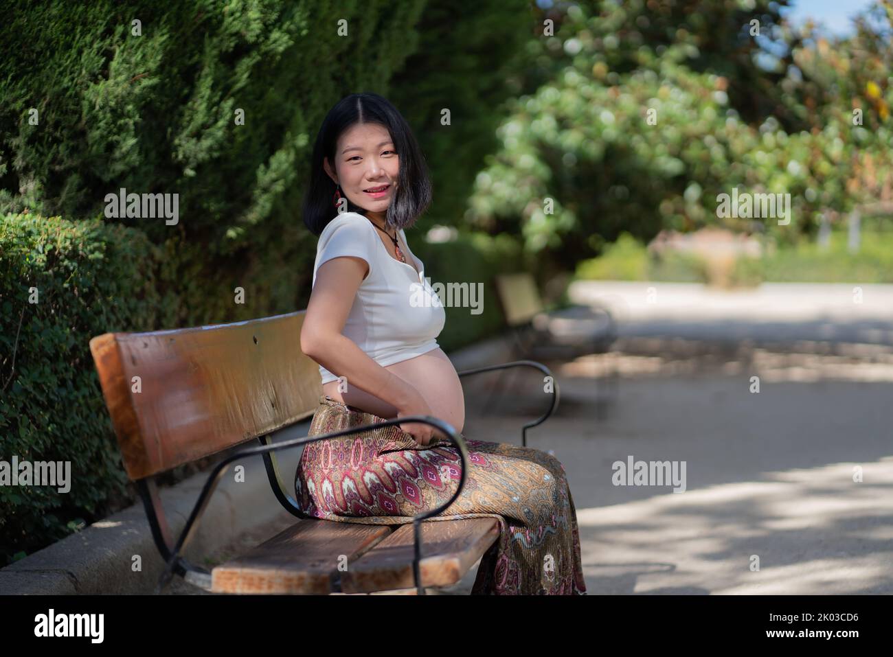 young happy and beautiful Asian Chinese woman pregnant showing her ...