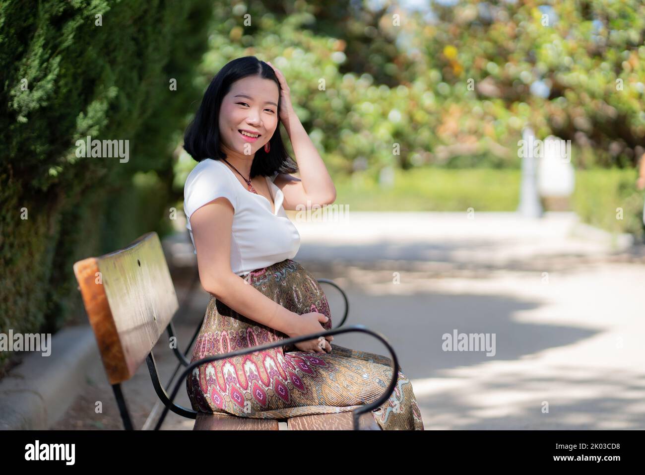 young happy and beautiful Asian Chinese woman pregnant showing her ...