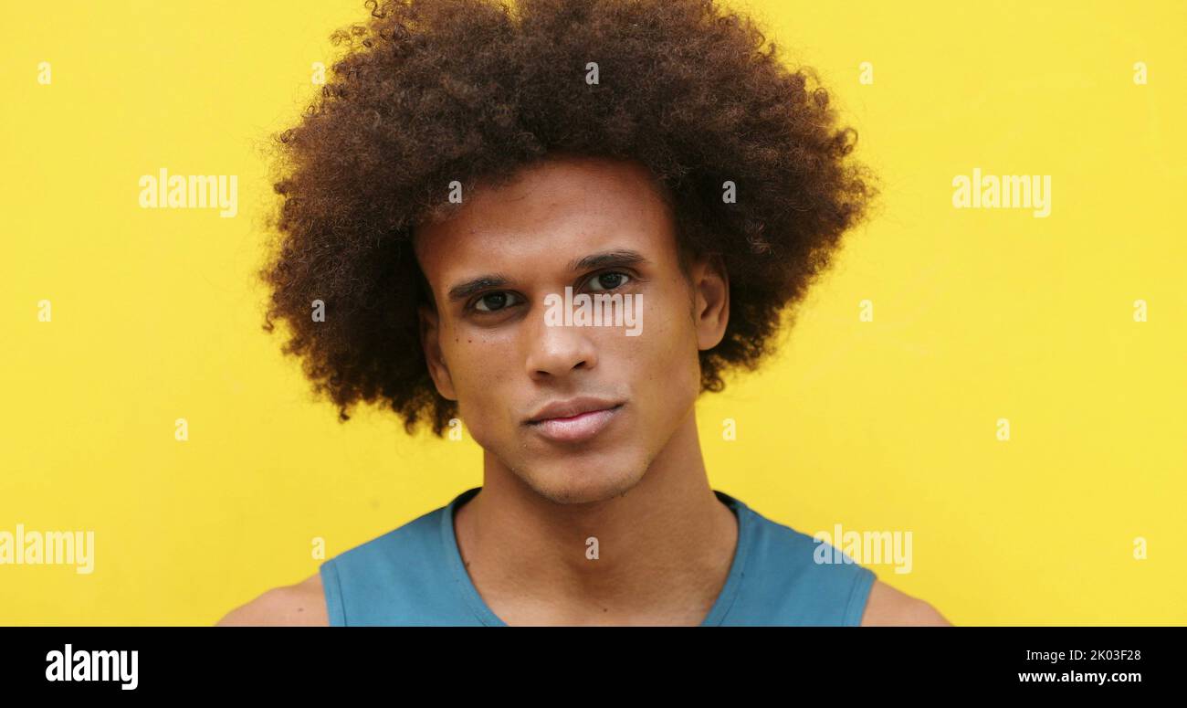African american Mixed race young man smiling in yellow background ...