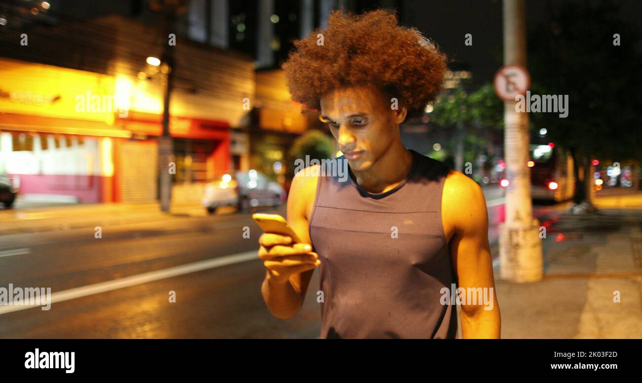 Young african man walking night hi-res stock photography and images - Alamy