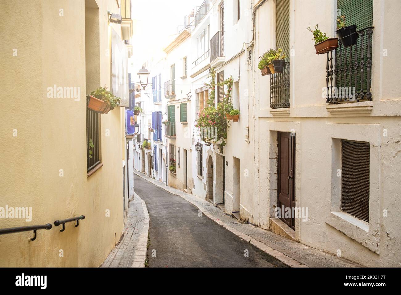 view of small street with white houses and flowers in the traditional ...