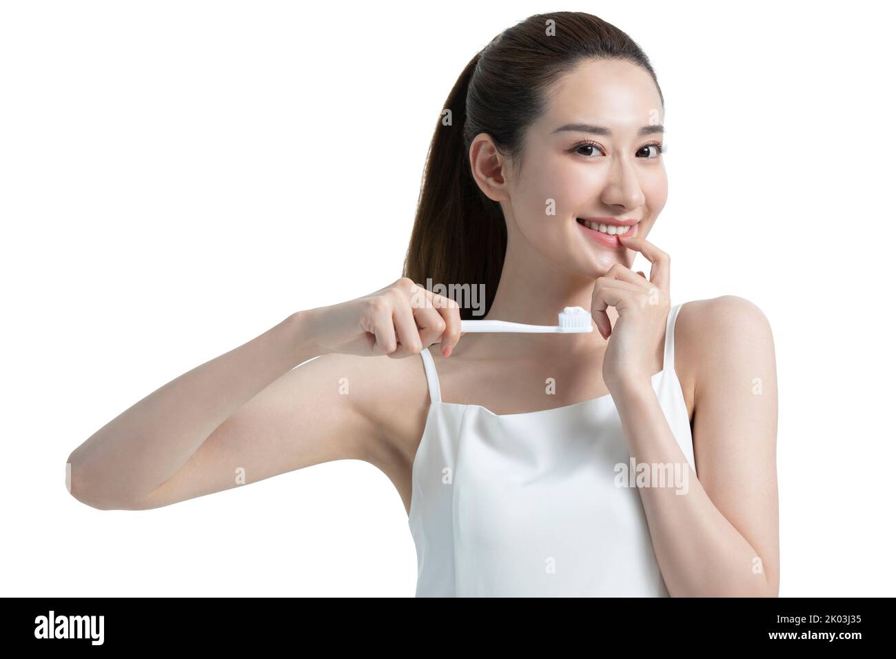 Beautiful young Chinese woman brushing teeth Stock Photo - Alamy