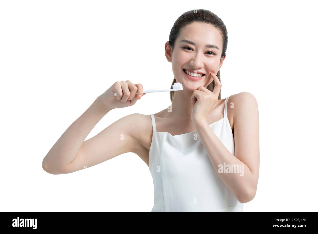 Beautiful young Chinese woman brushing teeth Stock Photo - Alamy