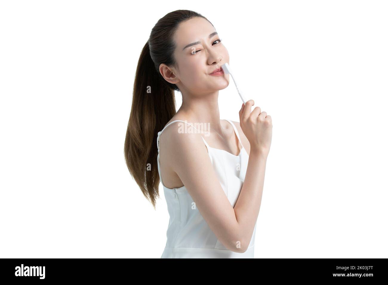 Beautiful young Chinese woman brushing teeth Stock Photo - Alamy