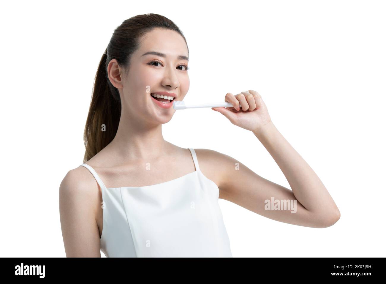 Beautiful young Chinese woman brushing teeth Stock Photo - Alamy