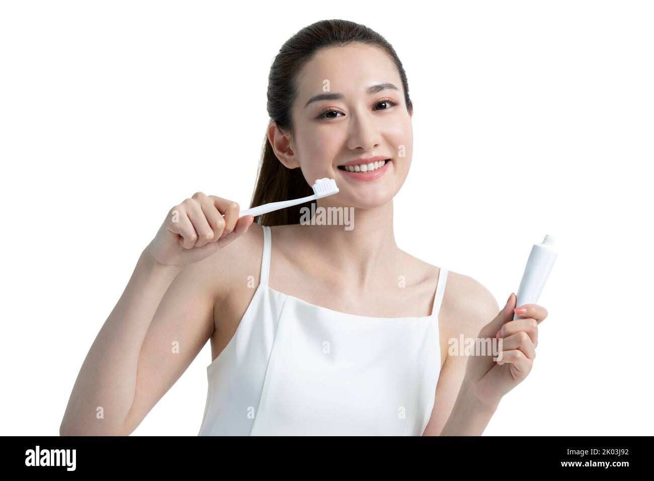 Beautiful young Chinese woman brushing teeth Stock Photo - Alamy