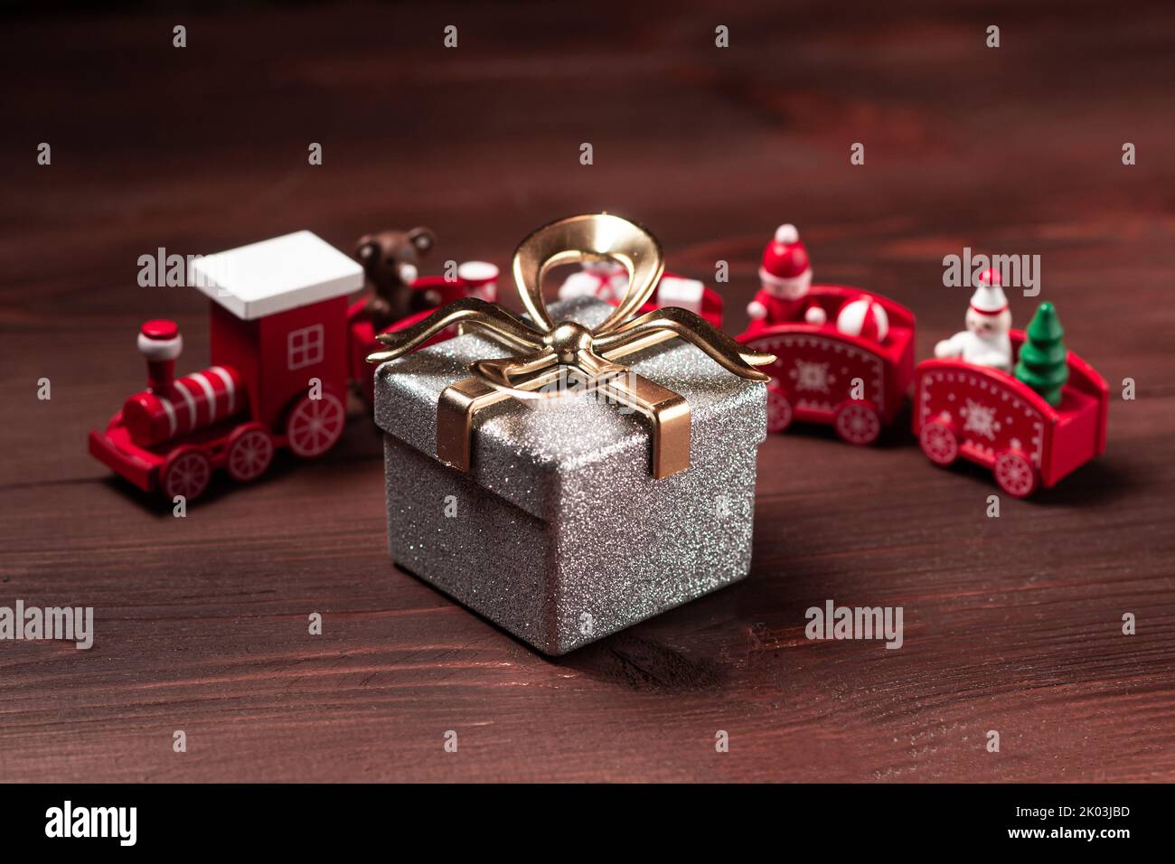 New year gift concept. Bright box with a bow and a New Year's train on ...
