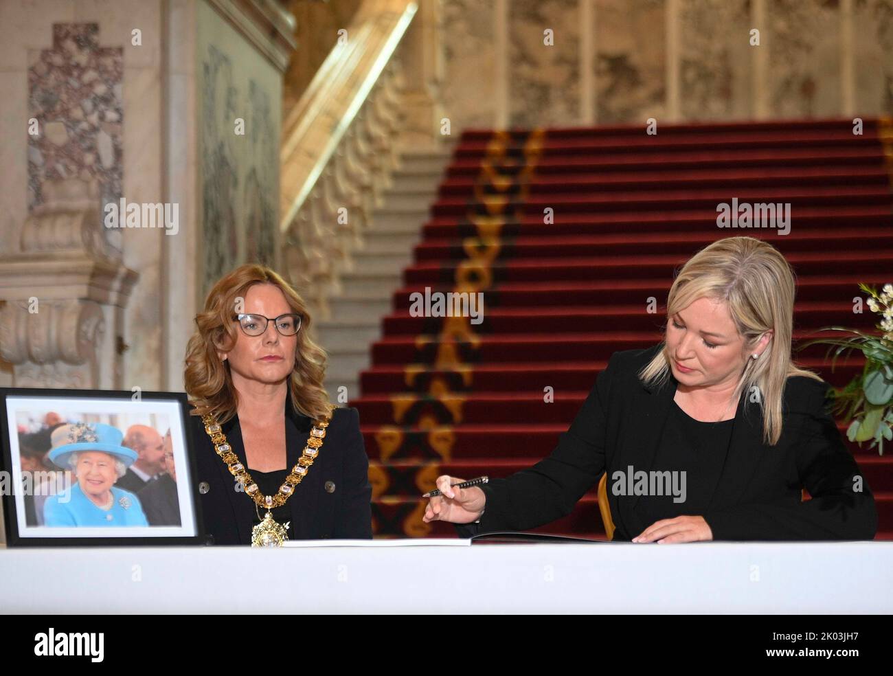 Sinn Fein Leader Michelle O'Neill (right) signs a Book of Condolence at ...