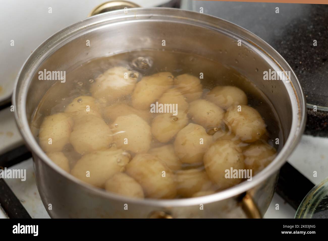 Potatoes boiling in a saucepan. Cooking young potatoes Stock Photo - Alamy