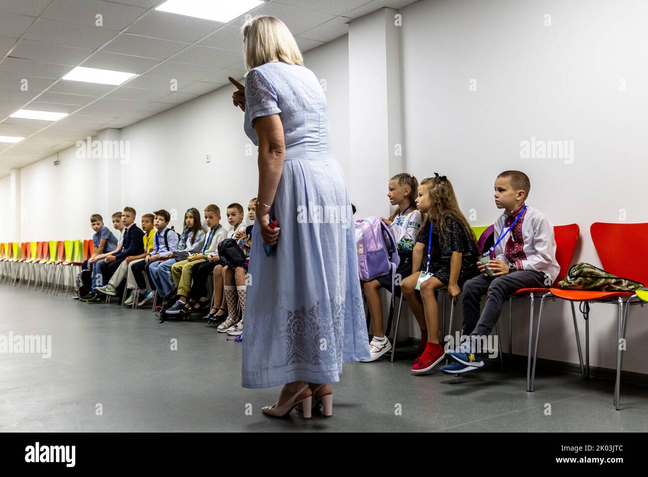 Children receive a training in a bomb shelter from a teacher how to ...