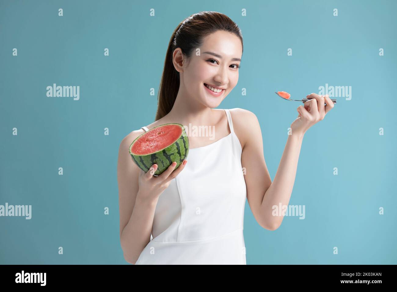 Beautiful young Chinese woman with watermelon Stock Photo - Alamy