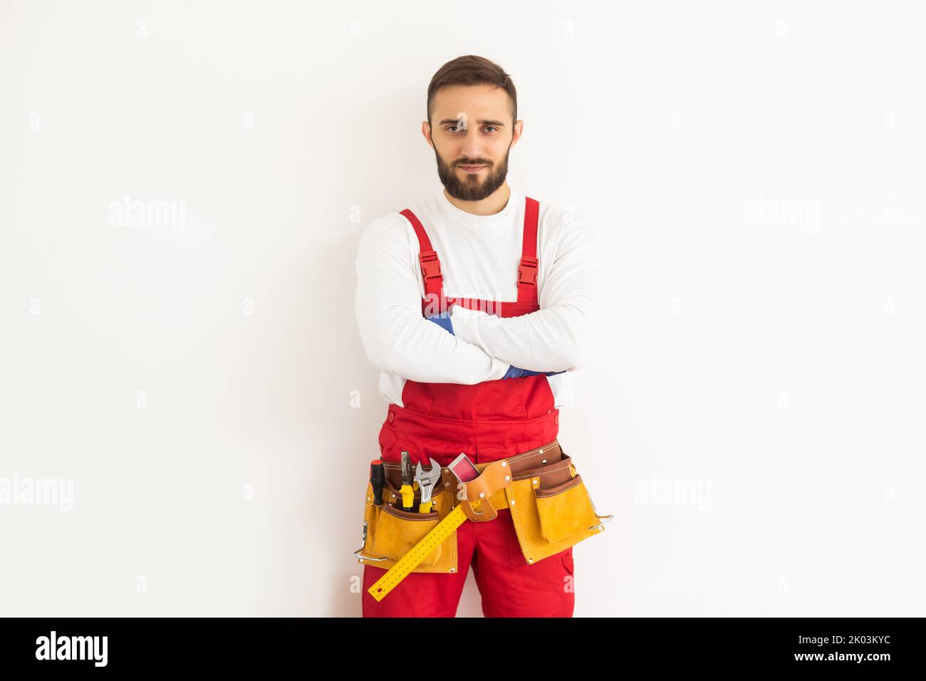 Man builder in a robe, overalls on a white background. Isolate, copy ...