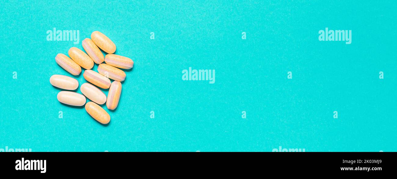 Tablets drugs therapy antibiotic on pastel blue background from above ...