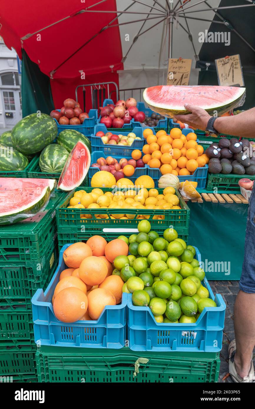 man buys watermelon from fruit dealer on the market Stock Photo - Alamy