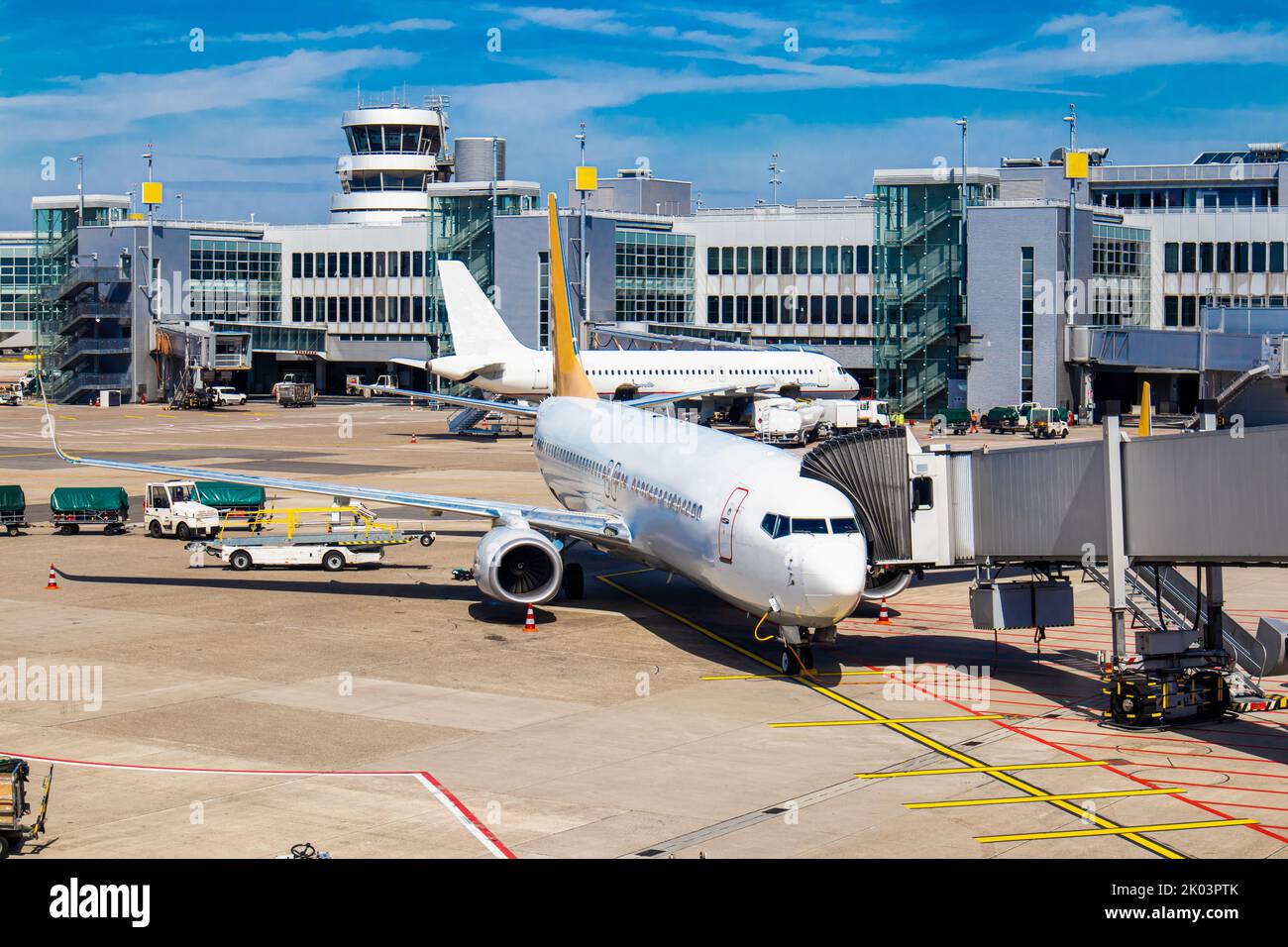 Passenger plane at the Airport near the terminal stands Stock Photo - Alamy