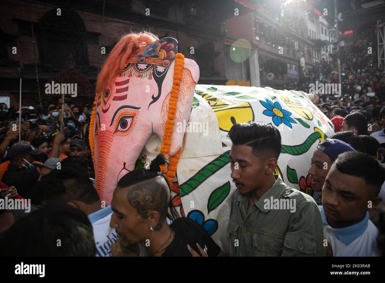 A masked dancer locally known as "Pulukisi" performs during a chariot ...